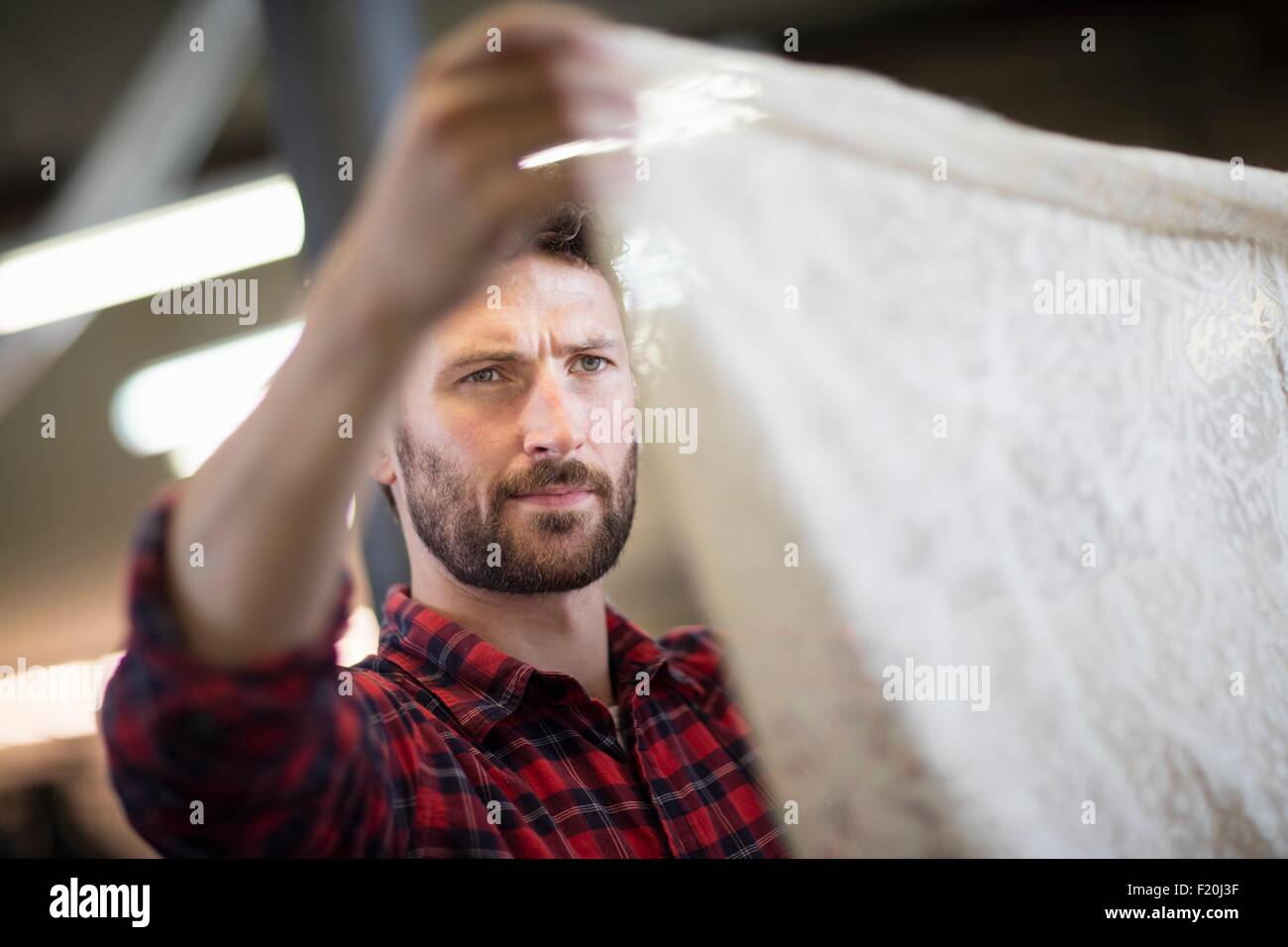 Male weaver checking lace textile in old textile mill Stock Photo - Alamy