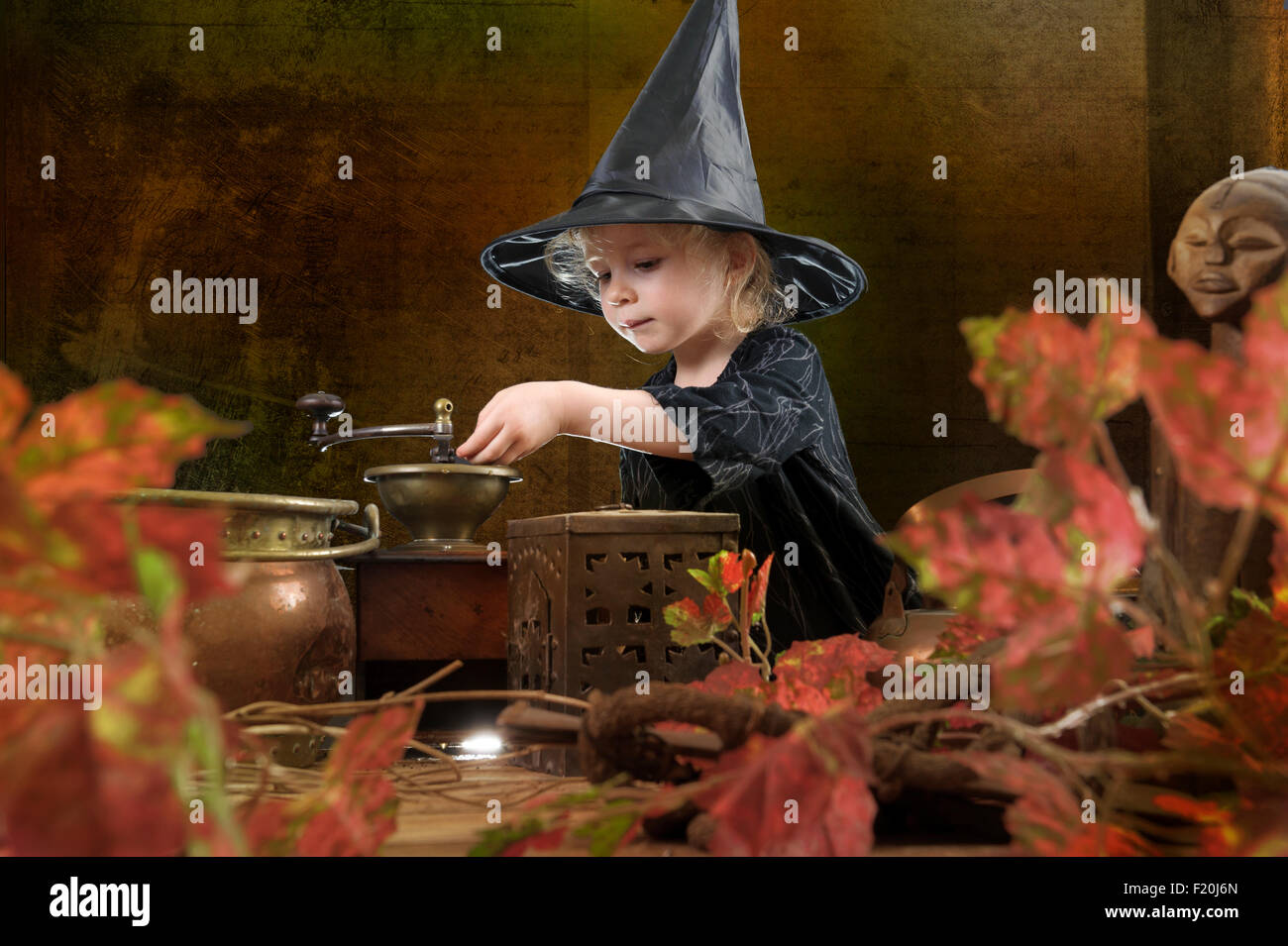 little halloween witch with cauldron Stock Photo - Alamy