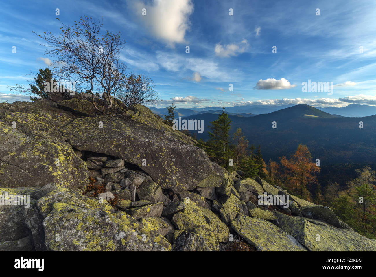 View of the stony hills glowing by evening sunlight. Dramatic autumn ...