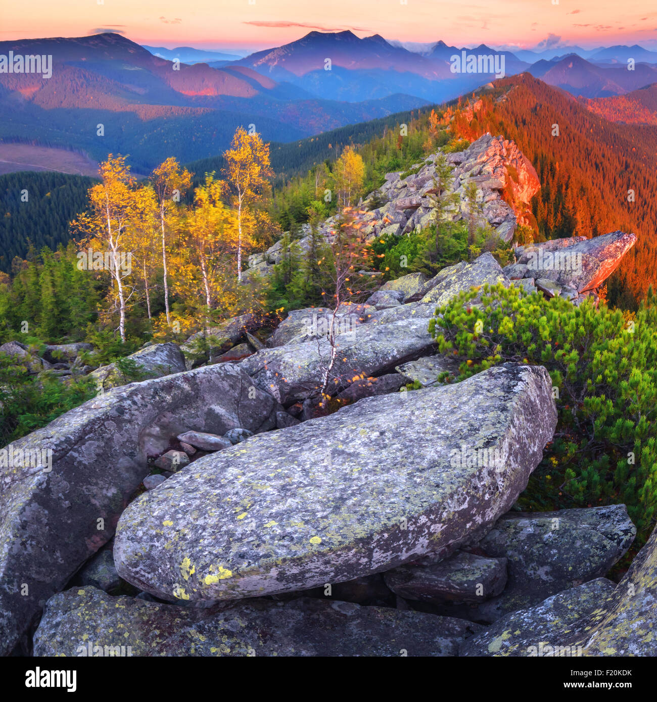 View of the stony hills glowing by evening sunlight. Dramatic autumn ...