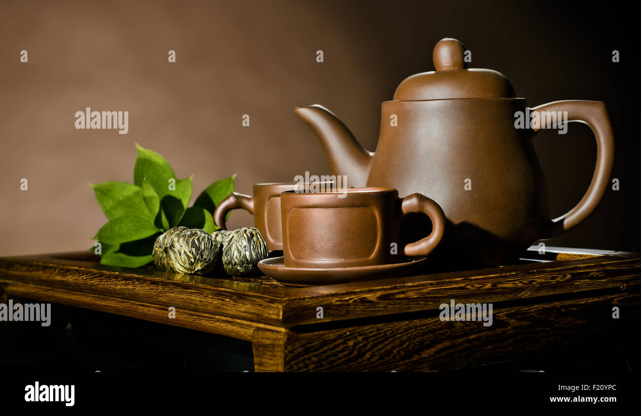 horizontal photo, still life of the clay teapot and cup on brown ...