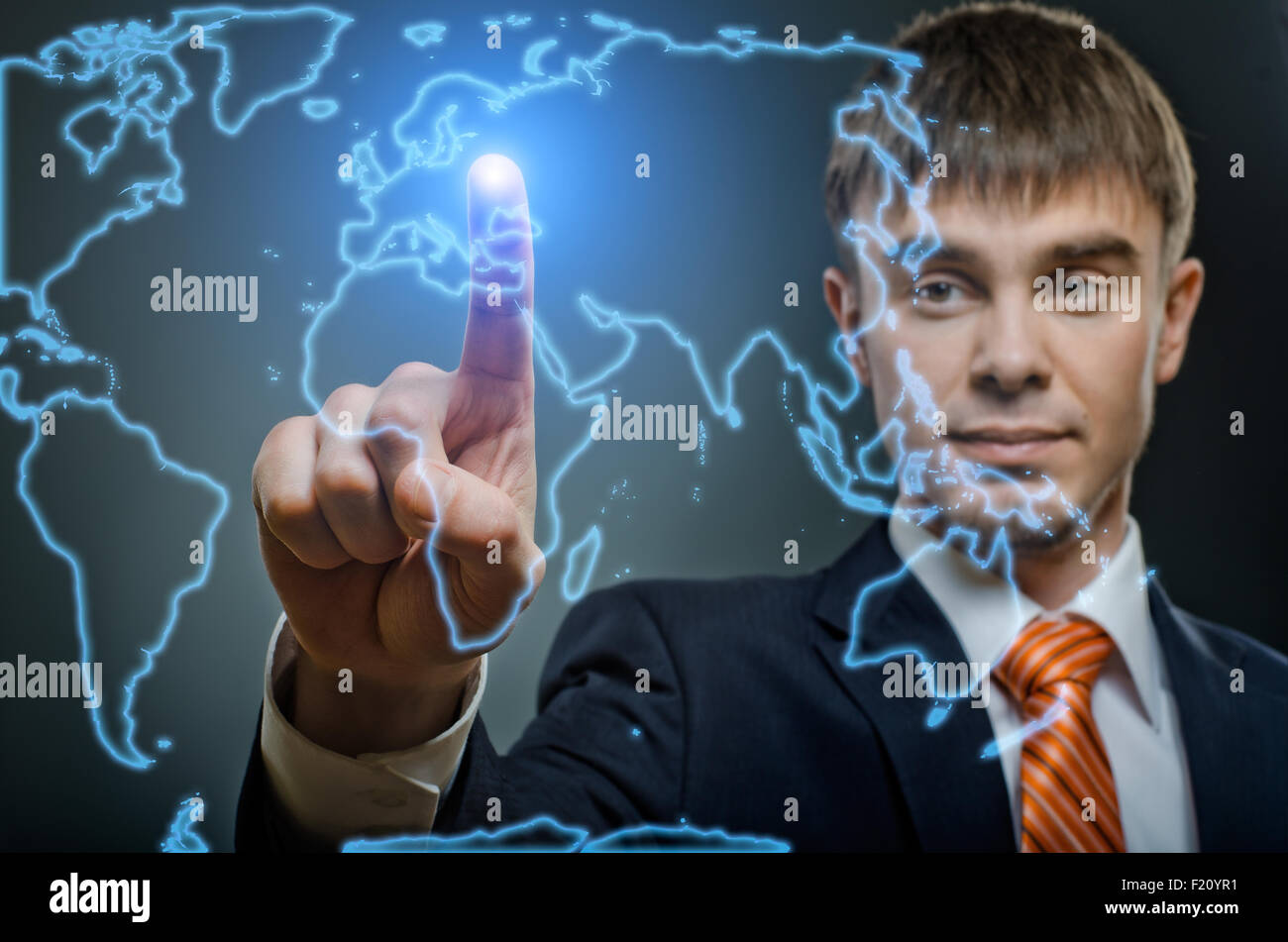 handsome businessman finger point touch on world map, on dark blue ...