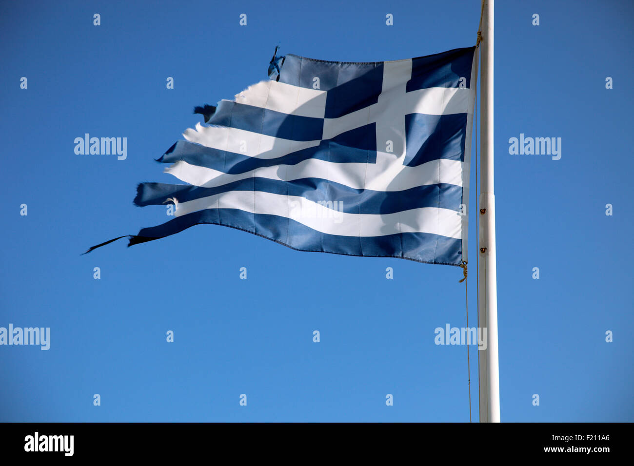 Tattered Greek flag flying in Ialyssos Rhodes Stock Photo - Alamy