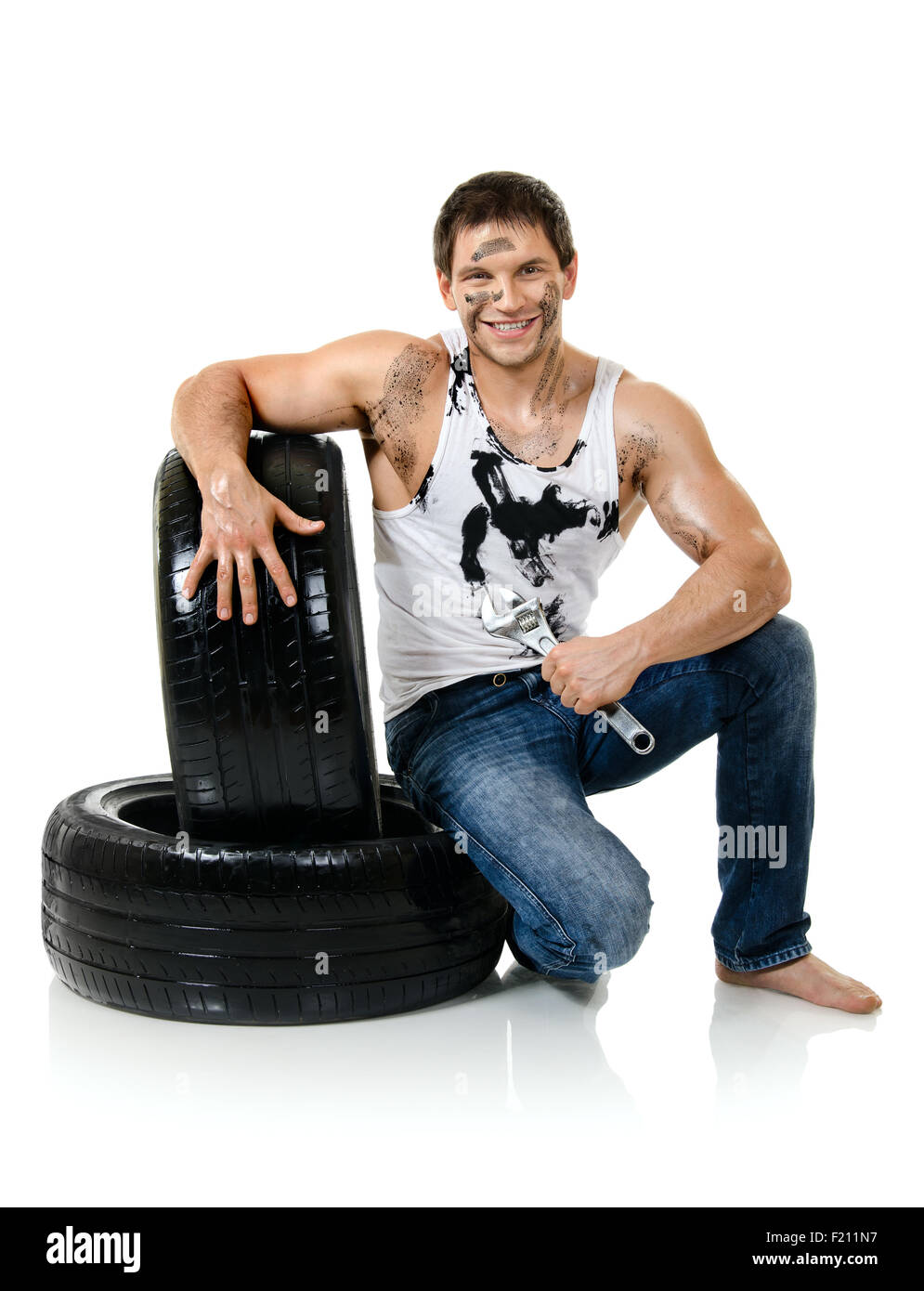 muscular handsome guy hold rubber-tire and white, on white background ...