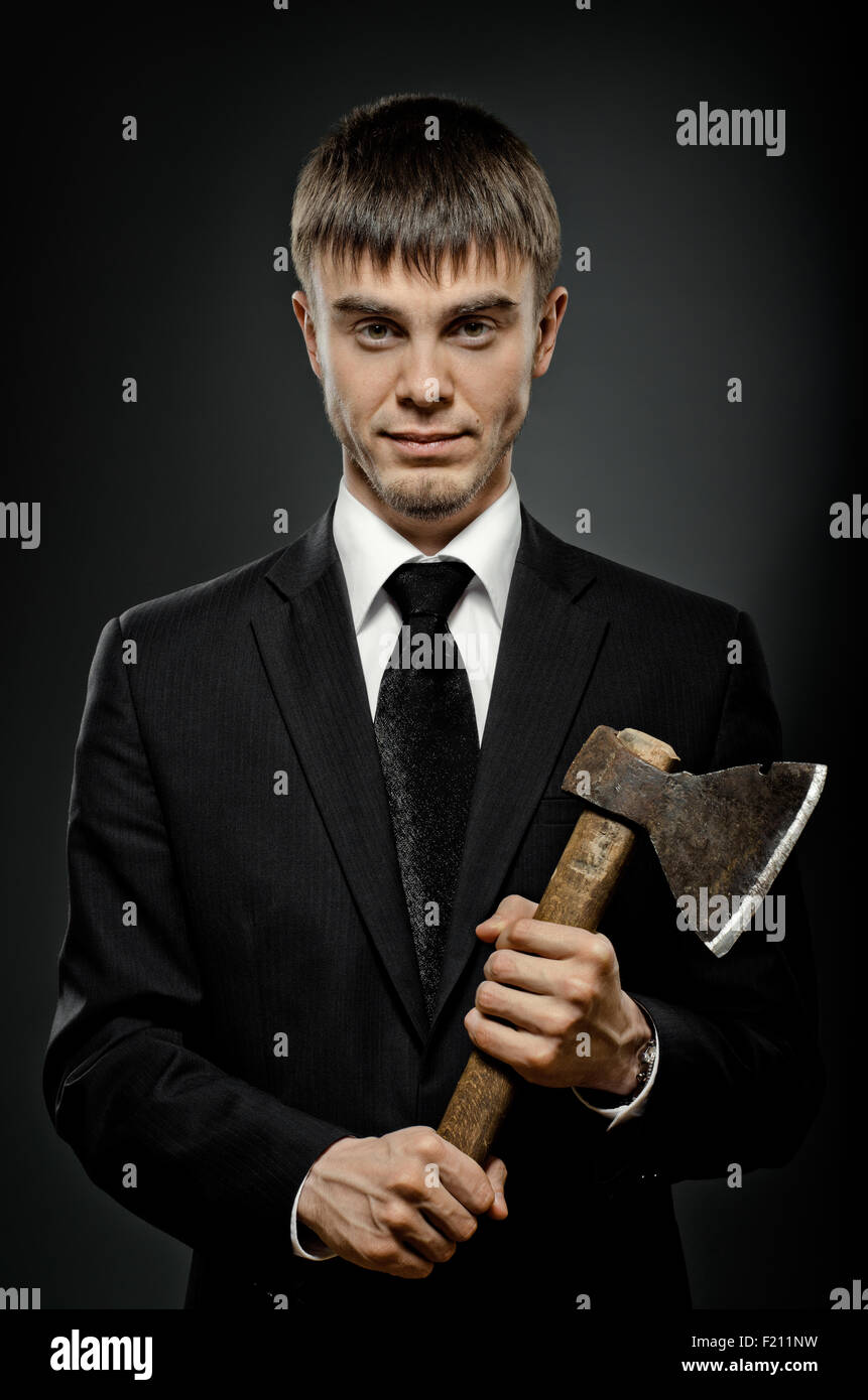 portrait man in black costume and black necktie with axe, sinister look ...
