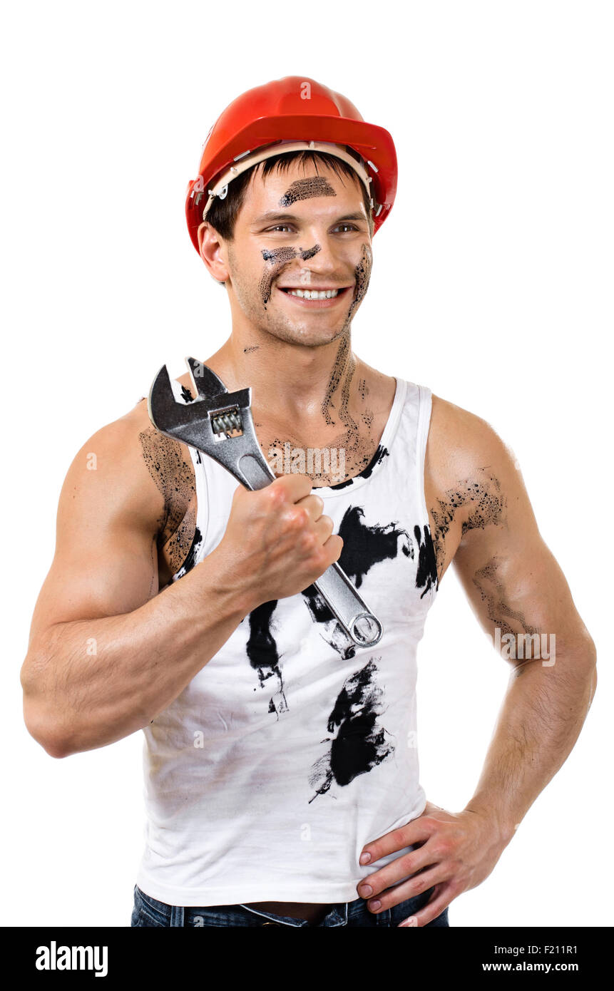 muscular worker man, in safety helmet hold big wrench in hands and ...