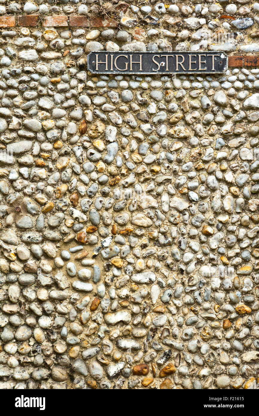 High Street sign on a typical flint built wall in Blakeney, North ...