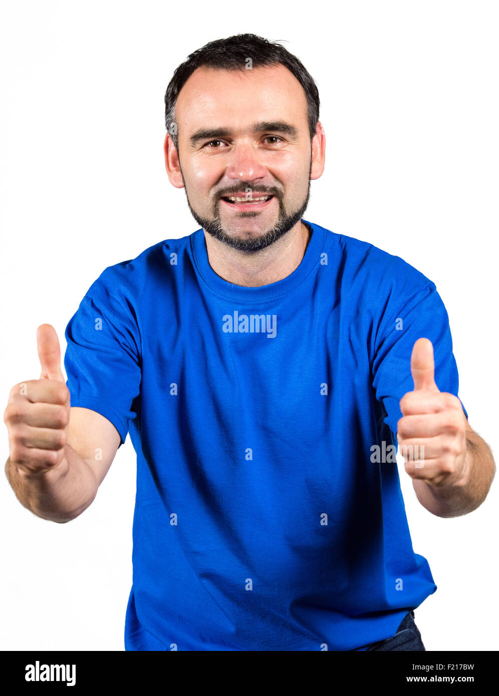 Positive bearded man wearing blue shirt showing thumb up isolated on ...