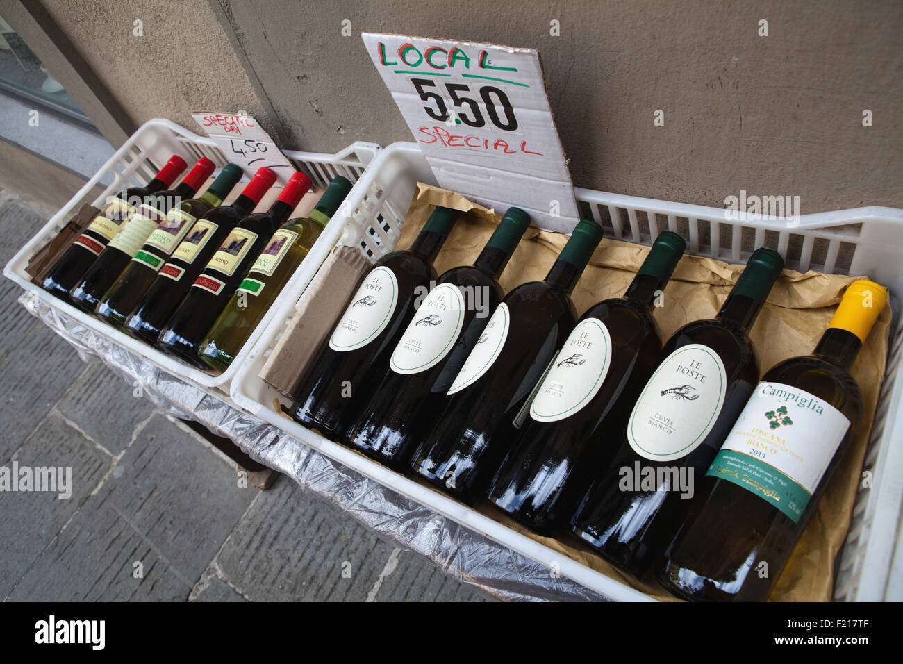 Italy, Tuscany, Lucca, Barga, Bottles of red & white wine for sale in ...
