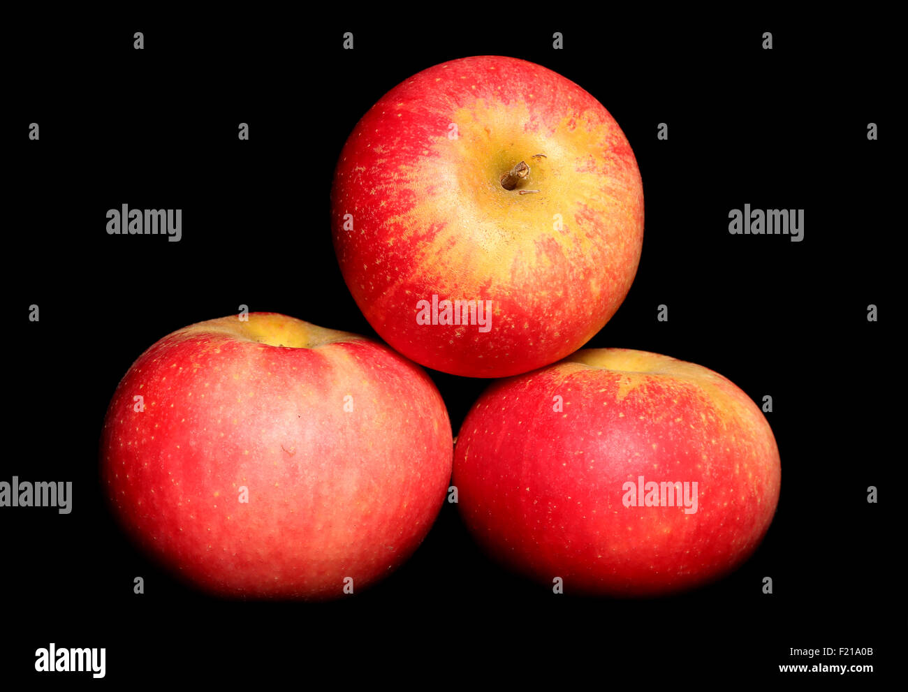 Three red apples on black background Stock Photo - Alamy