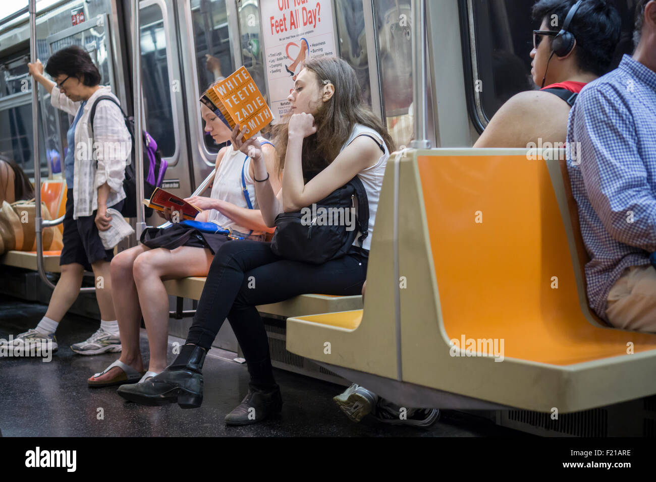 Woman reading book on subway hi-res stock photography and images - Alamy