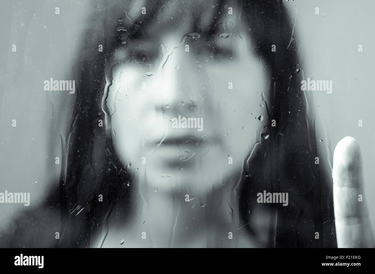 Portrait woman behind wet glass hi-res stock photography and images - Alamy
