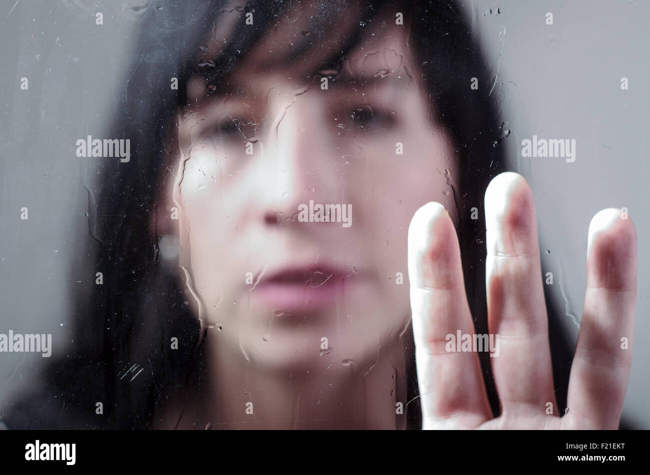 Closeup portrait of brunette girl behind glass Stock Photo - Alamy