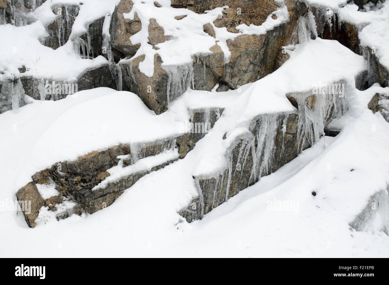 Snow and ice covering granite rocks Stock Photo - Alamy