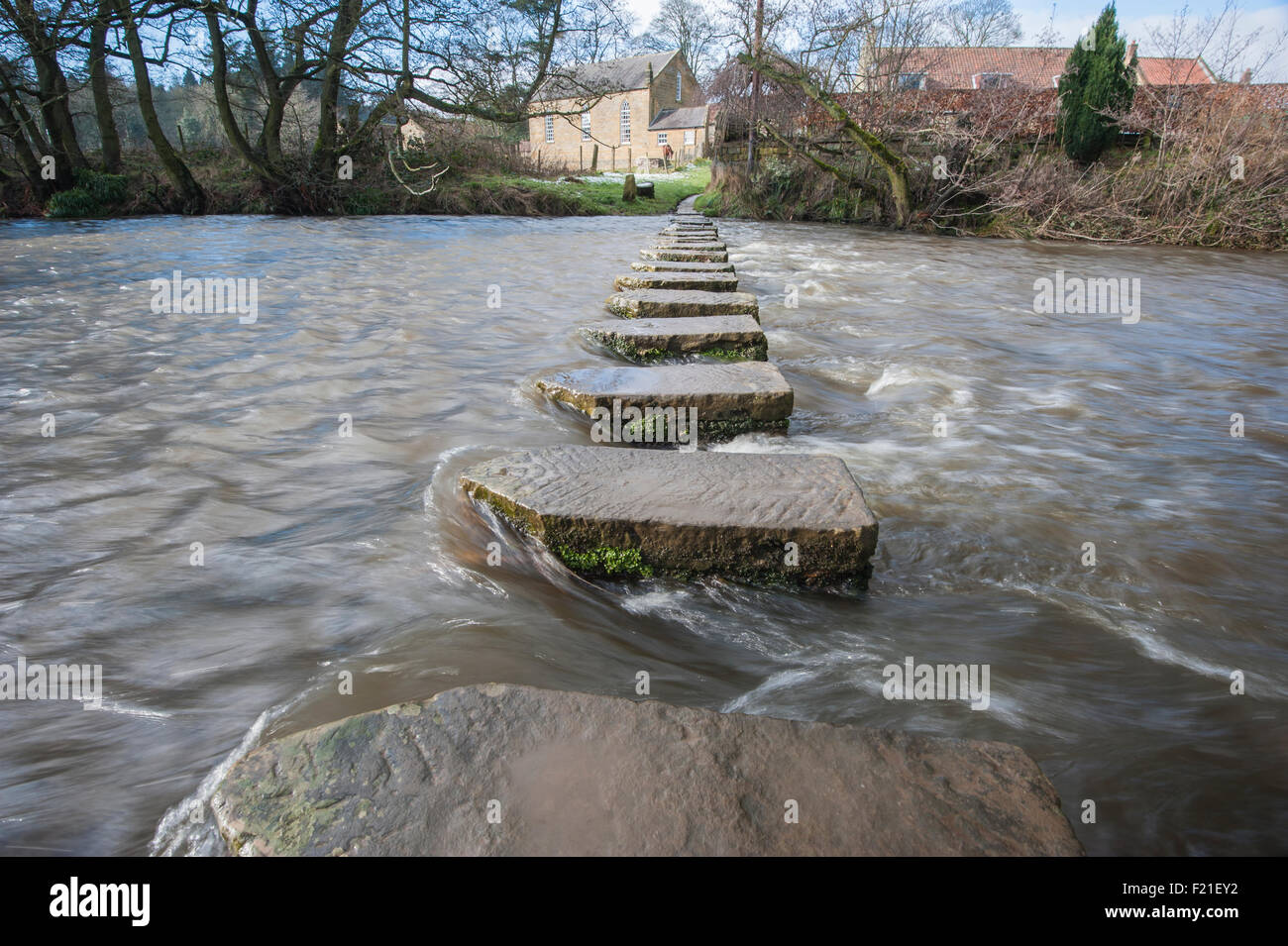 Stepping stones across a small river in english rural village ...