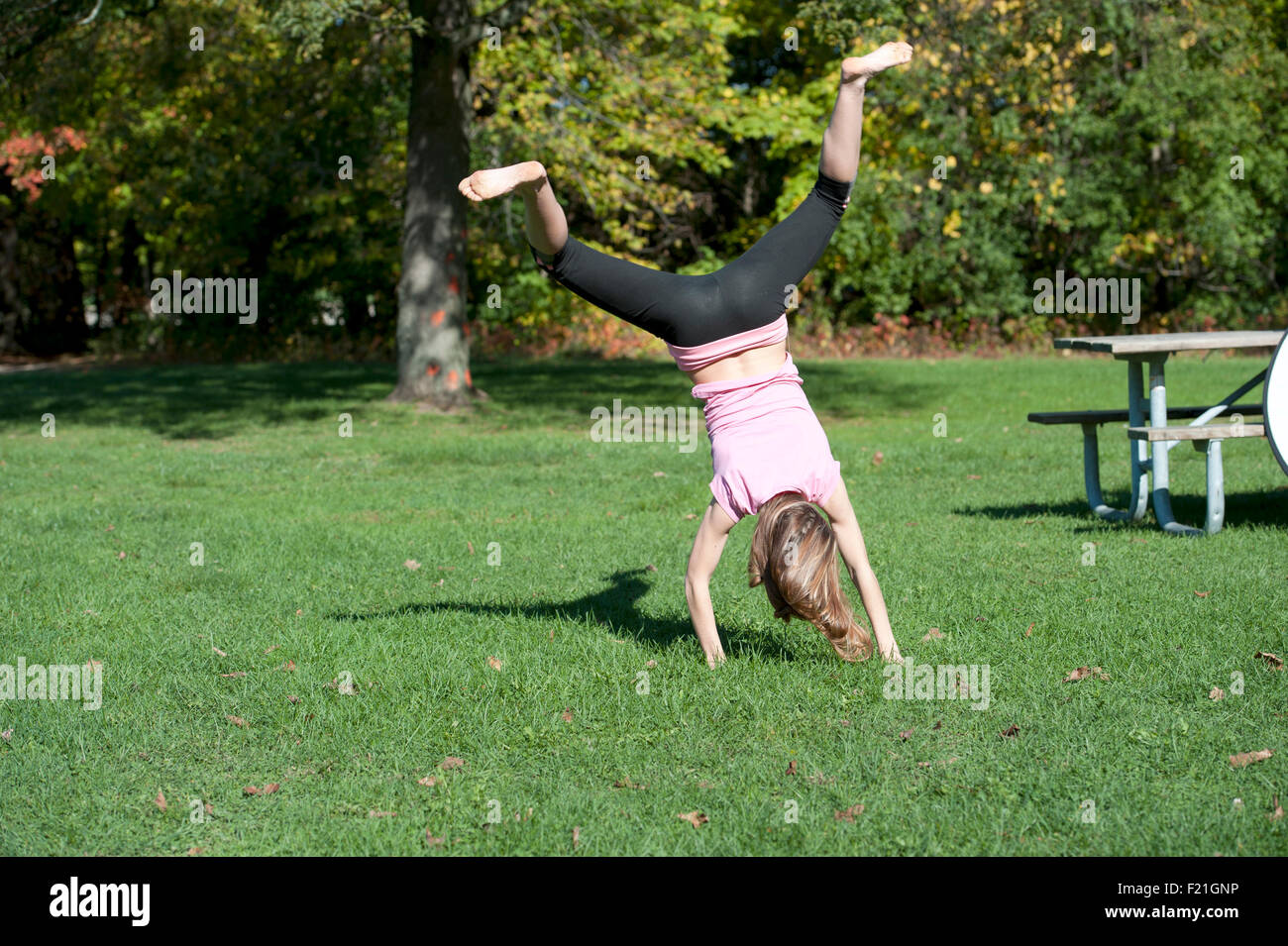 A model performing gymnastics on a sunny day outside Stock Photo - Alamy