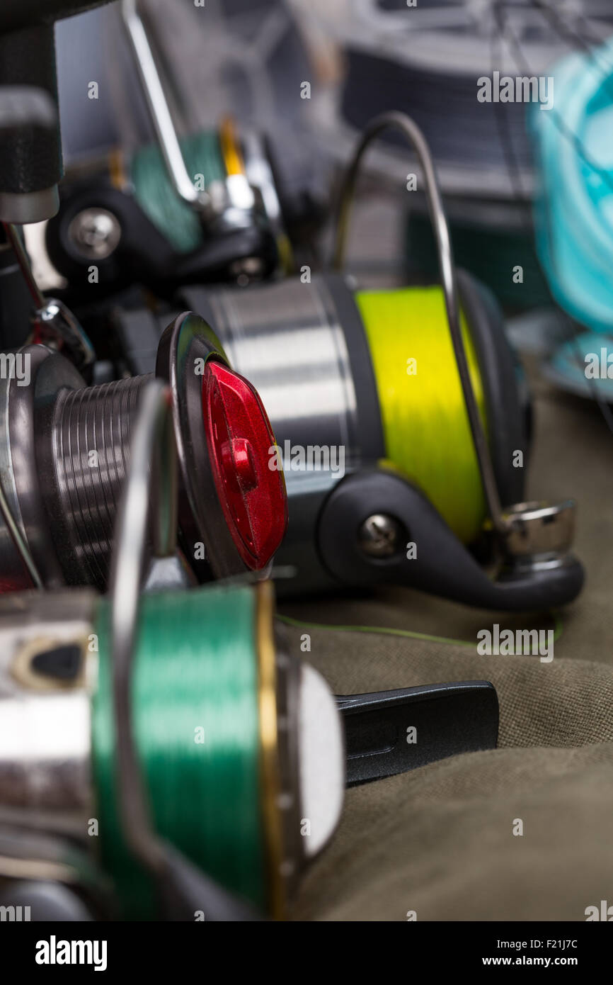 fishing reels with line different colors on cloth background Stock ...