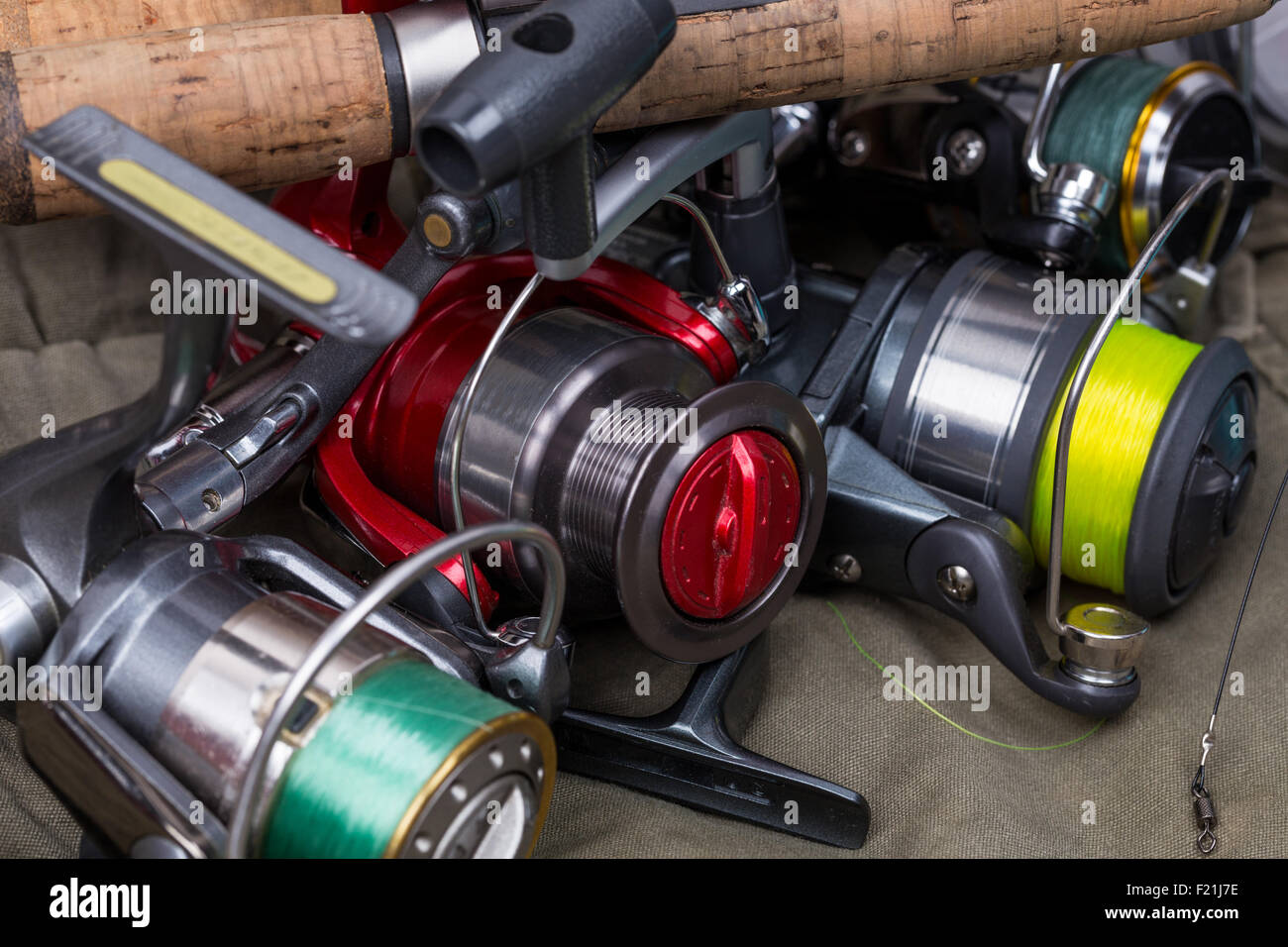 fishing reels with line different colors on cloth background Stock ...