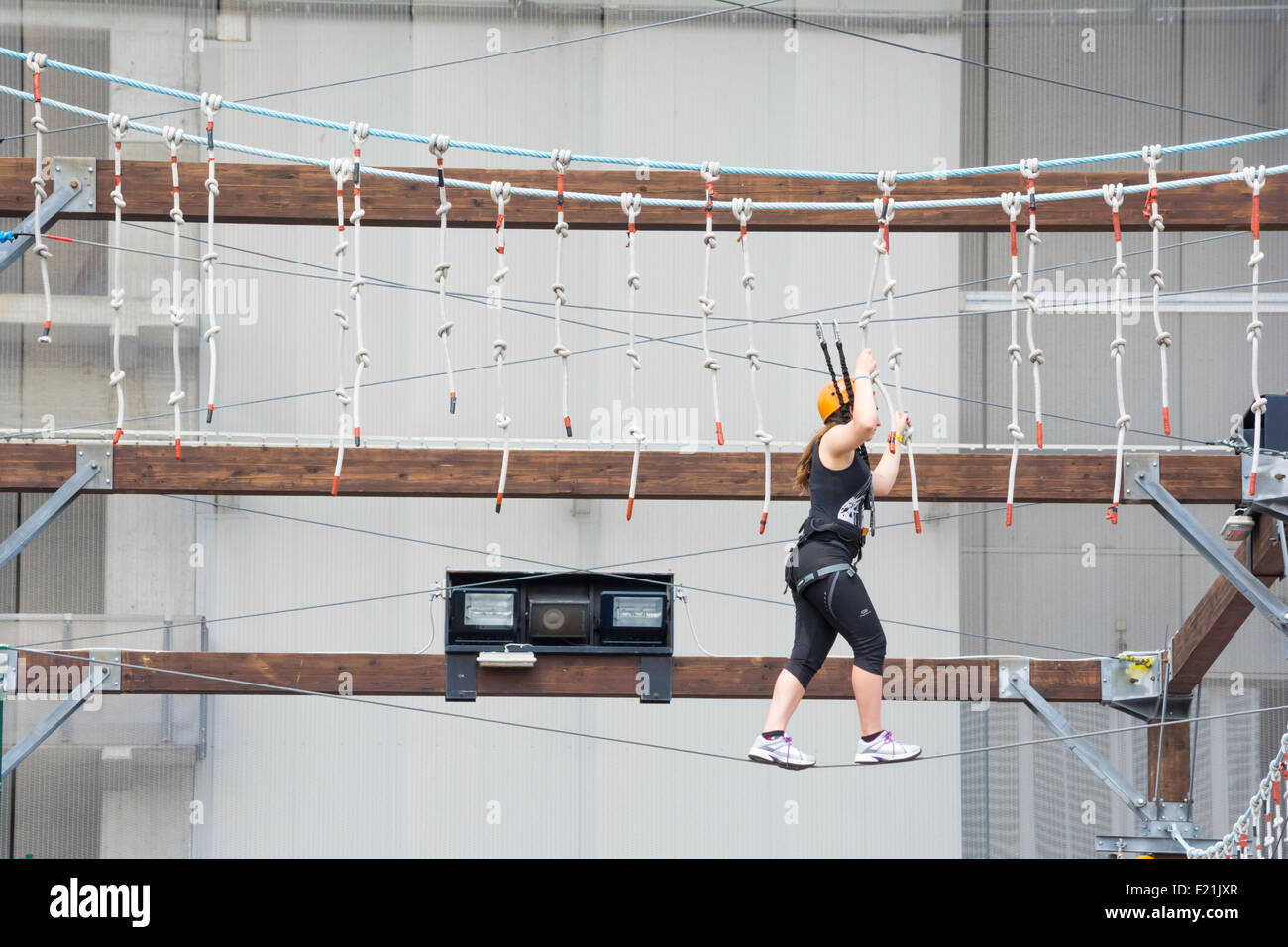 Bologna,Italy-May 31,2015:A girl hanging on a equipped path walks among ...