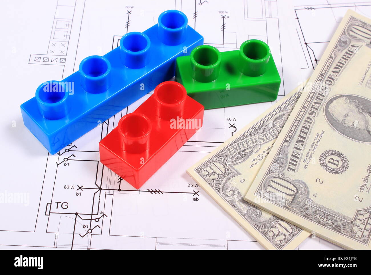 Heap of banknotes and plastic colorful building blocks lying on ...