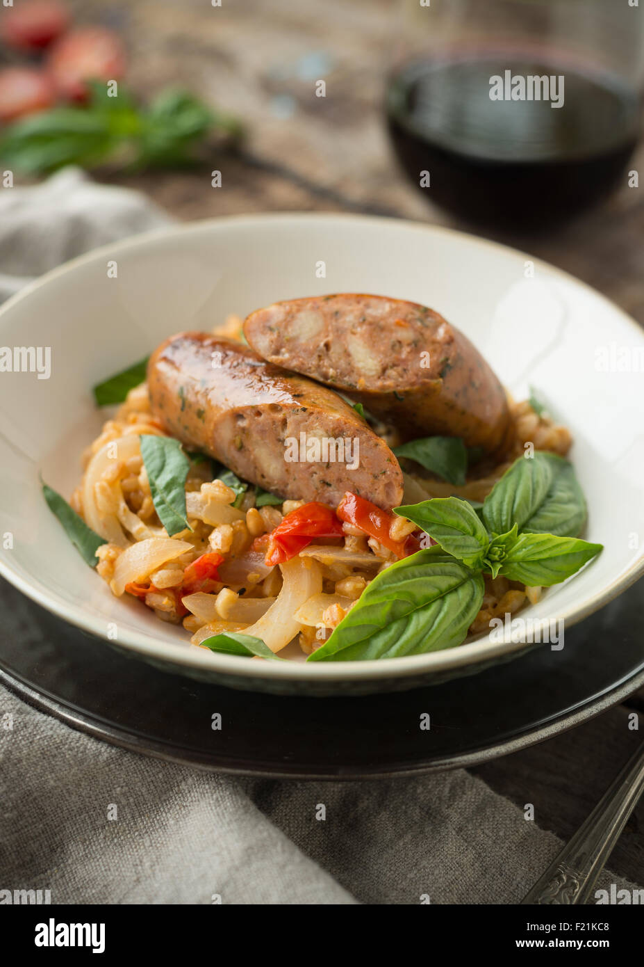 Grilled sausage over rice with sauteed vegetables Stock Photo - Alamy