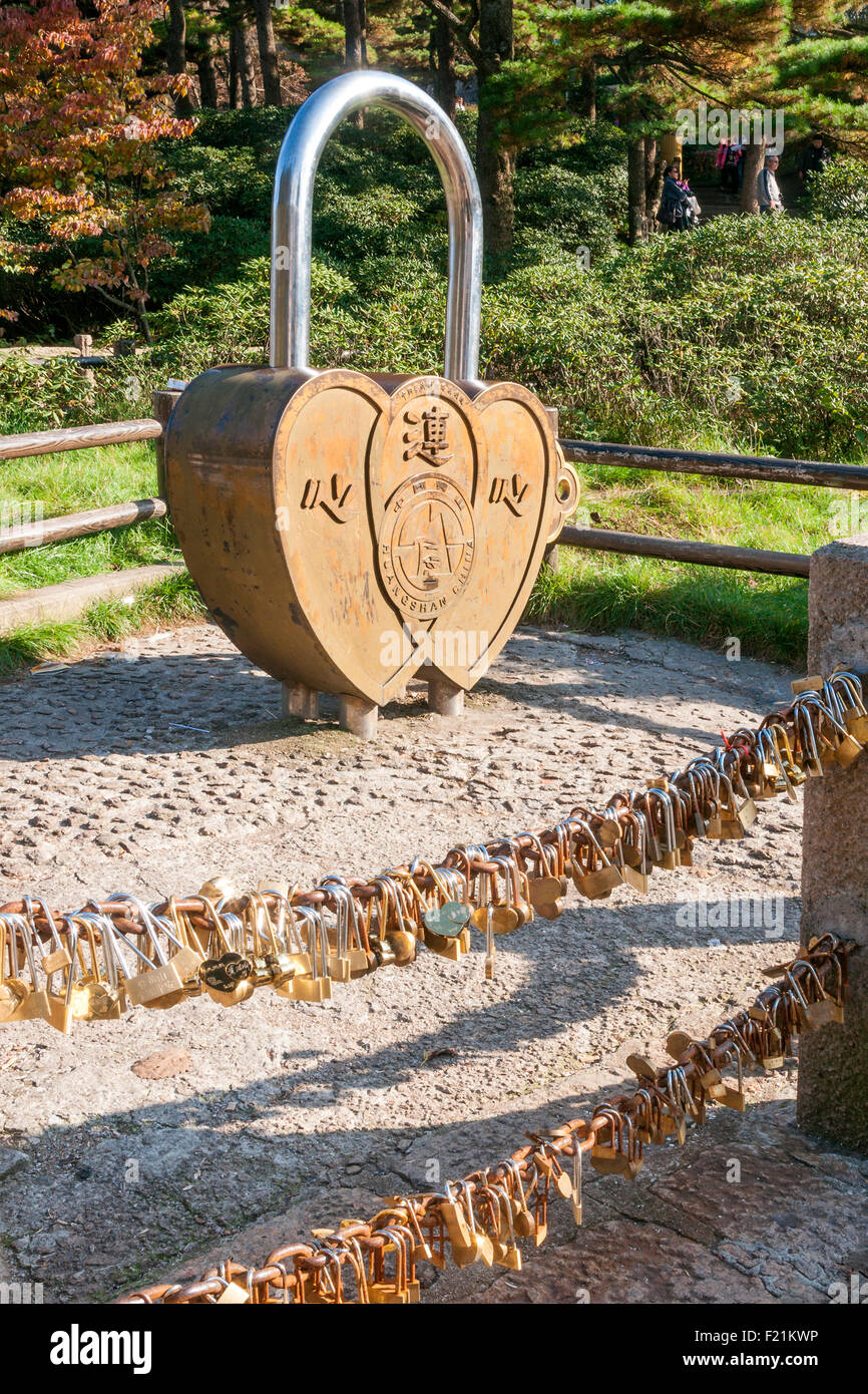 Large metal sculpture of heart-shaped lock behind rows of small ...