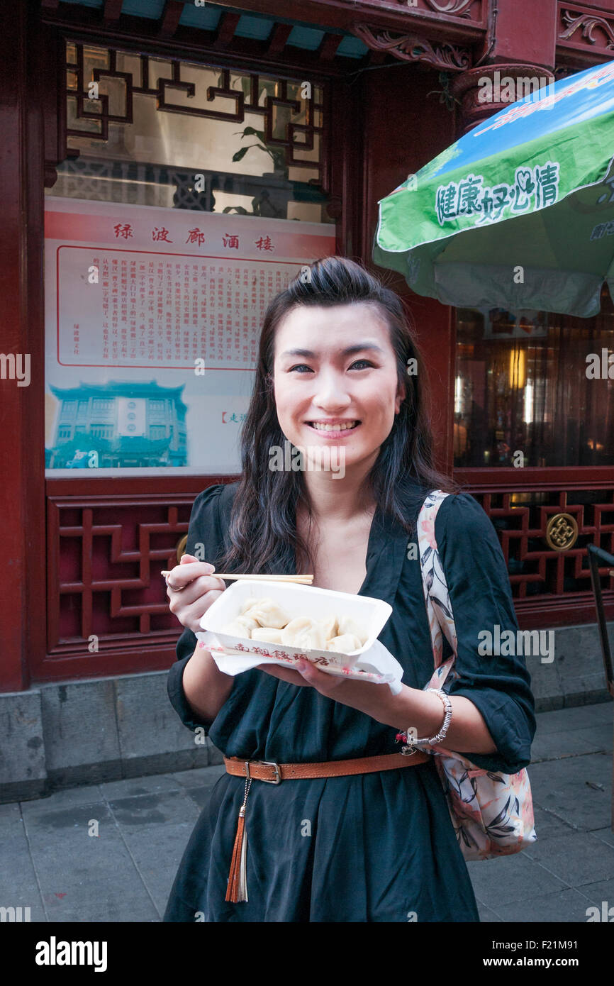 Smiling Asian Woman Holding Fresh Dumplings And Chopsticks Old Town