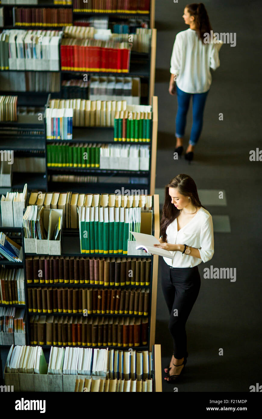 Young women in the library Stock Photo - Alamy