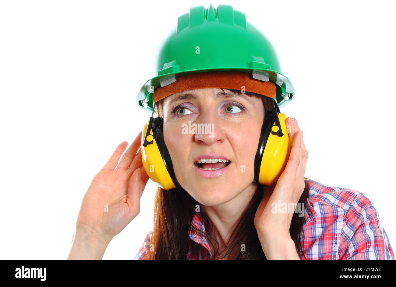 Female construction worker can not hear because wearing green helmet and protective headphones ...