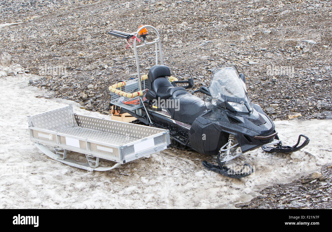 Black snowmobile in a winter mountain landscape Stock Photo - Alamy
