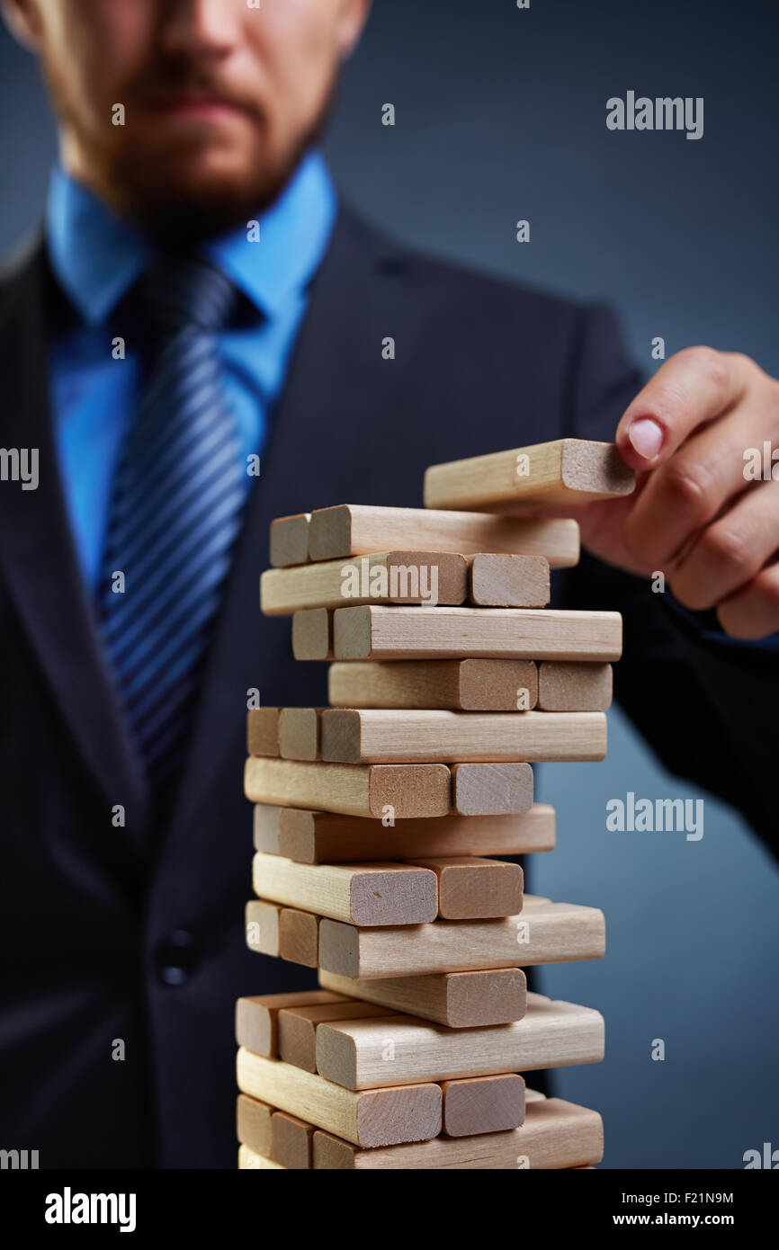 Business tower built by small wooden blocks Stock Photo - Alamy