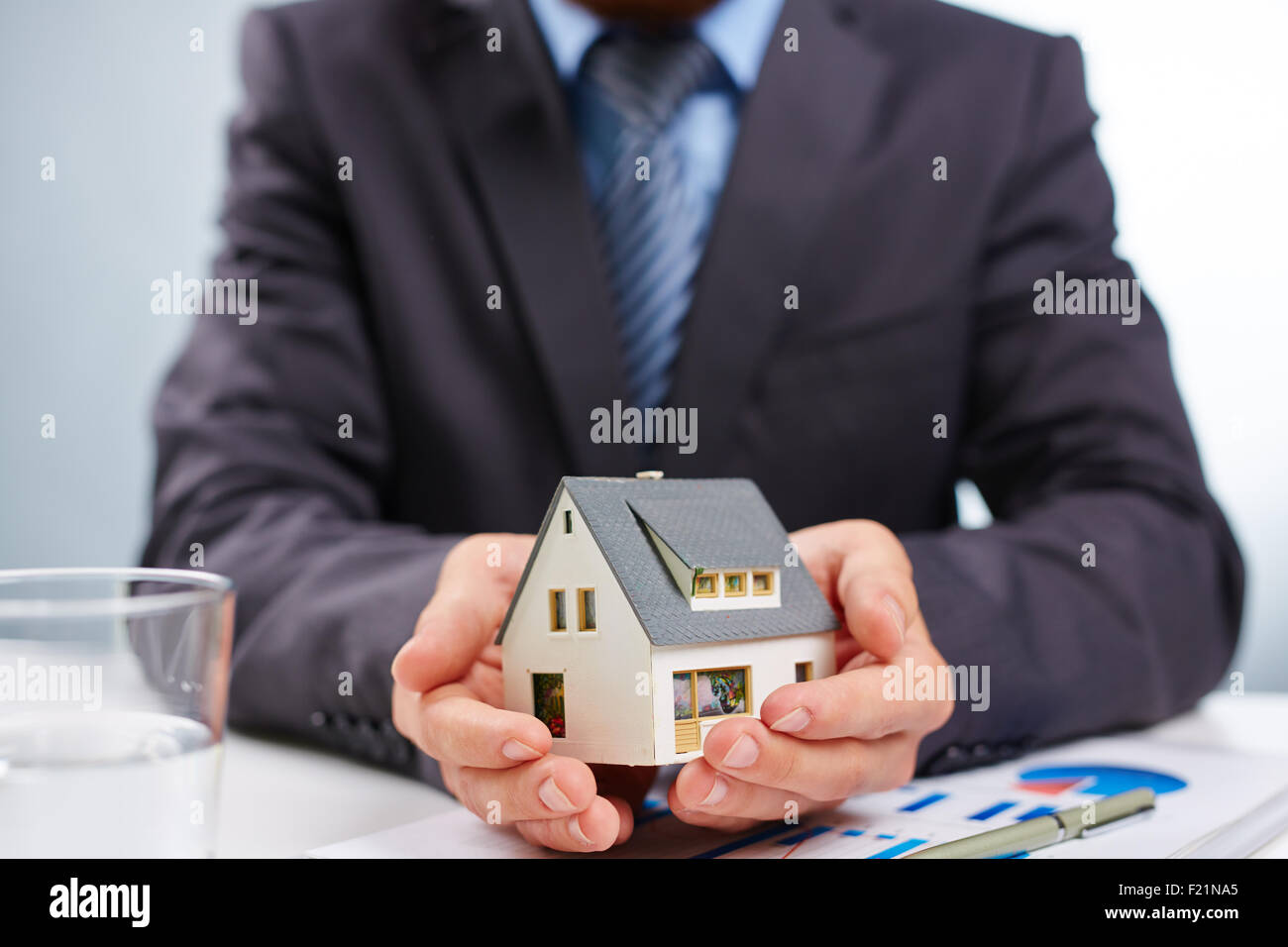 Human open palms with house model Stock Photo - Alamy