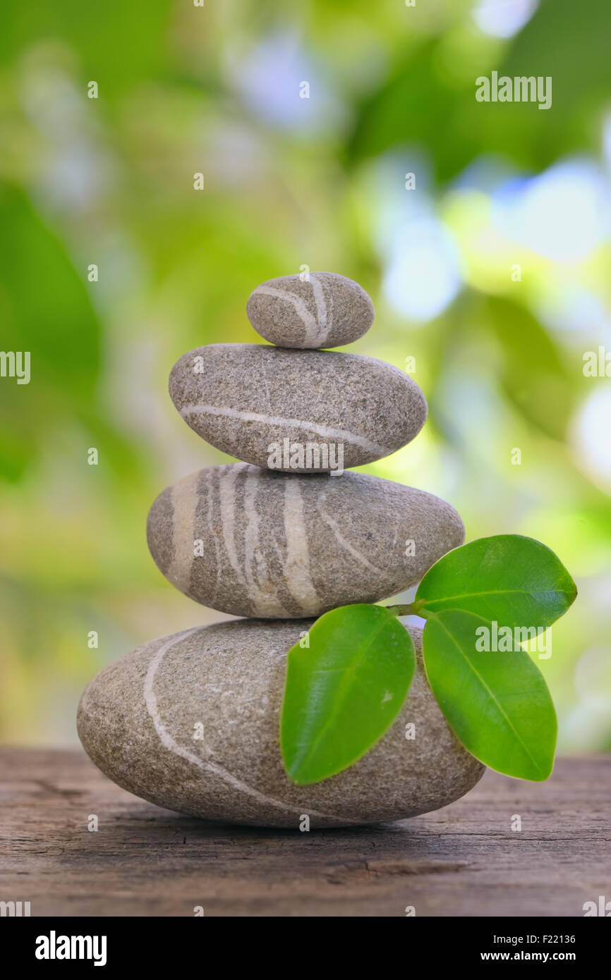 Stack of pebble on old wood Stock Photo - Alamy