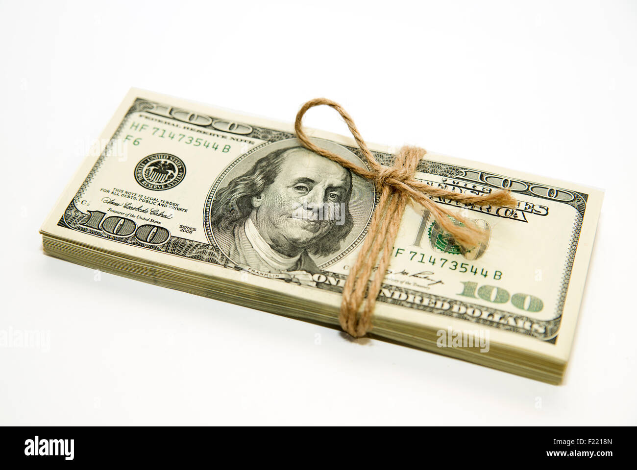 One pack of dollars tied up with rope on over white Stock Photo - Alamy