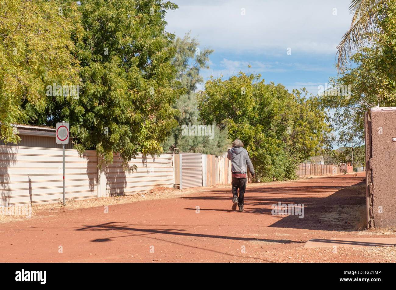 Aboriginal man walking down a residential street in the heart of ...