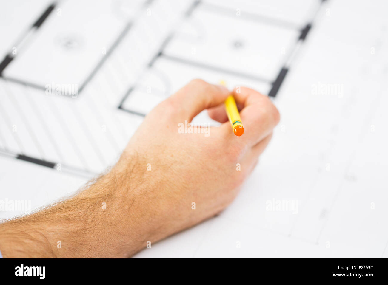 close up of male hand with blueprint and pencil Stock Photo - Alamy
