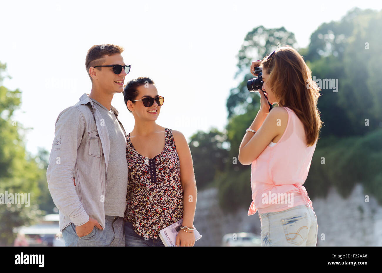 happy friends with camera taking picture outdoors Stock Photo - Alamy