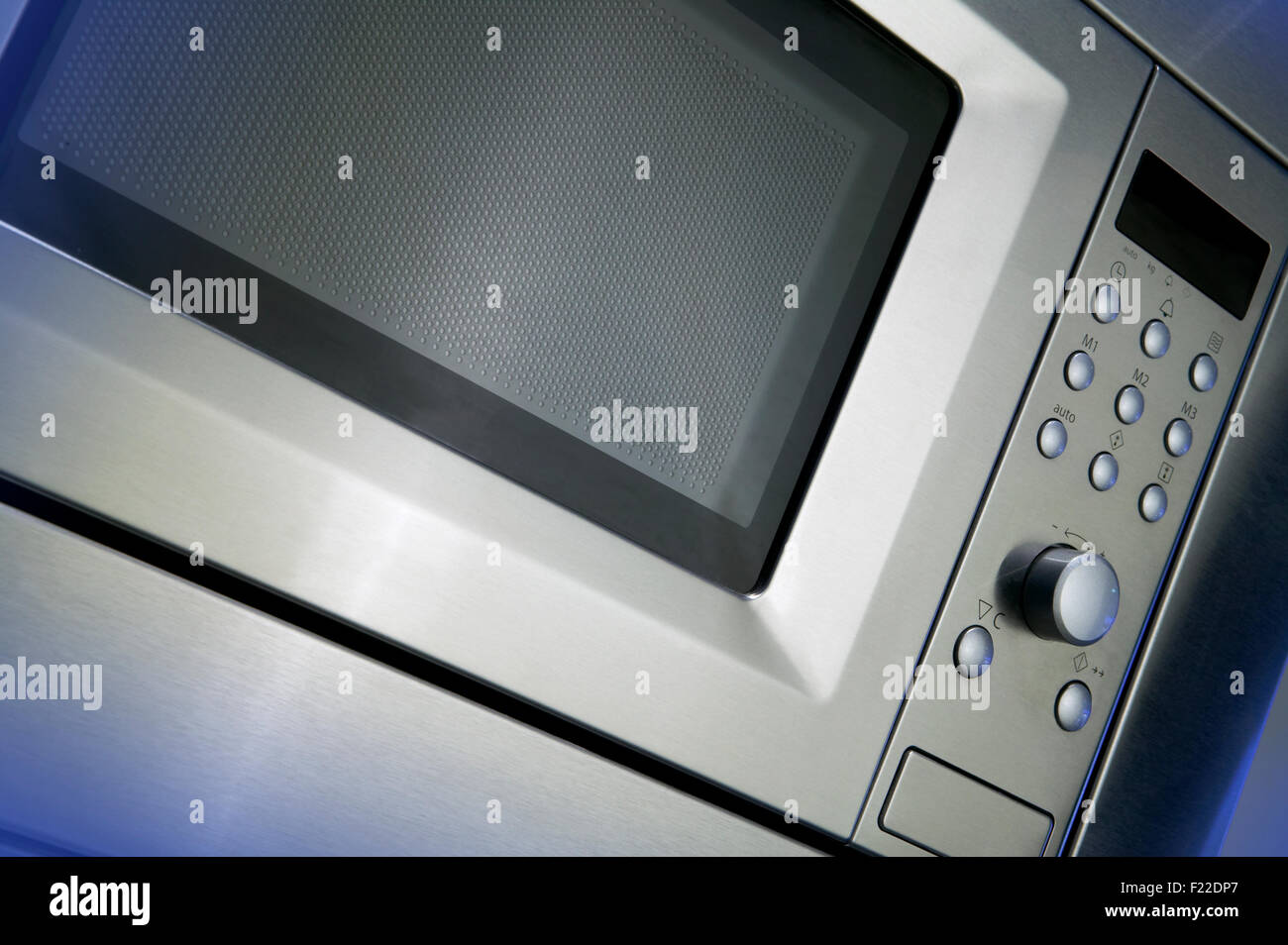 Microwave under a blue light close up Stock Photo - Alamy
