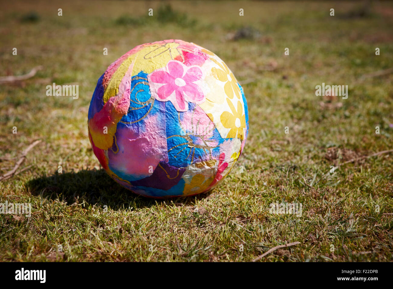 Color paper ball on a grass field Stock Photo - Alamy