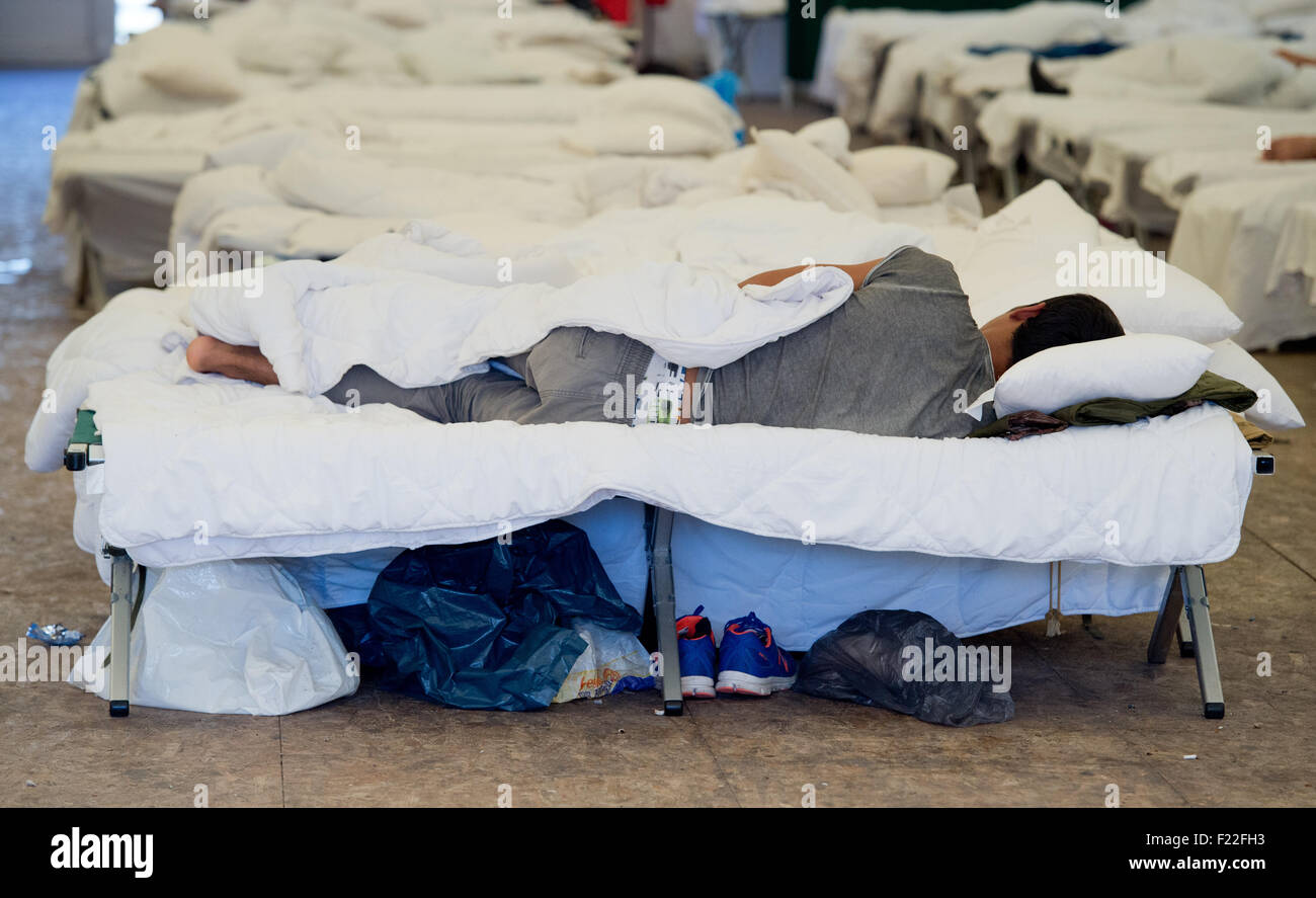 Giessen, Germany. 10th Sep, 2015. A refugee sleeps in his camp bed ...