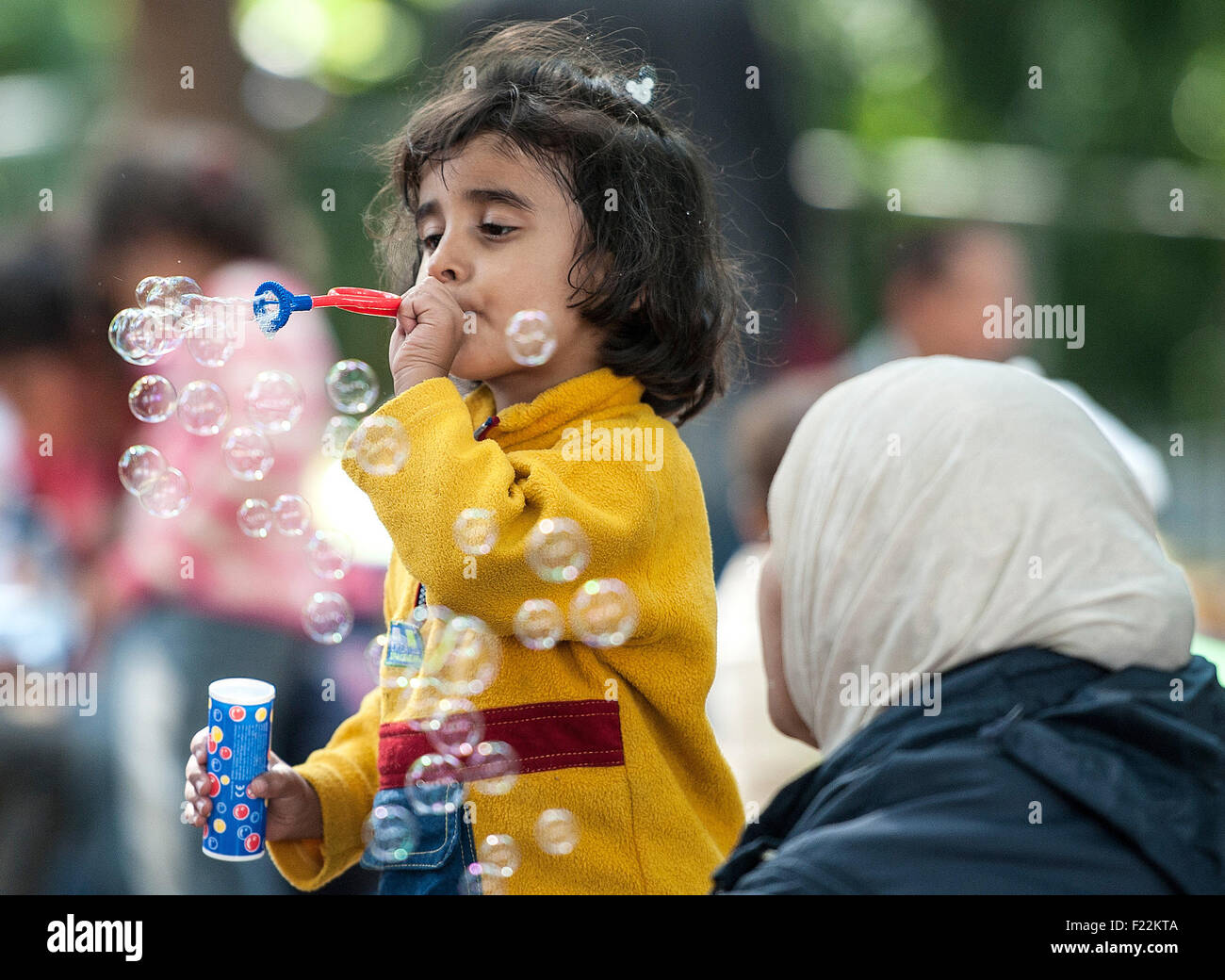 Fatier from Syria blows bubbles at the Rudolf-Harbig-Halle in Berlin ...