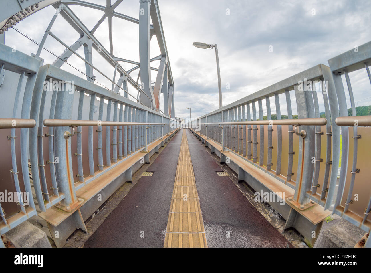 A fisheye shot of a ramp with hand rails on the sides leading to the ...