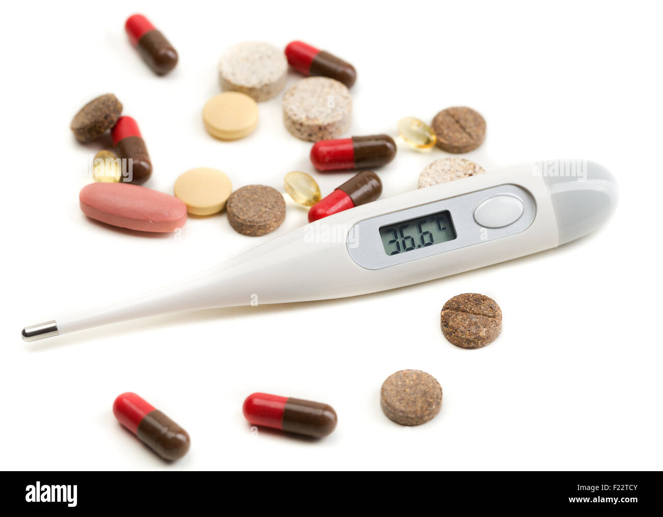 Electronic thermometer and pills isolate on white Stock Photo - Alamy