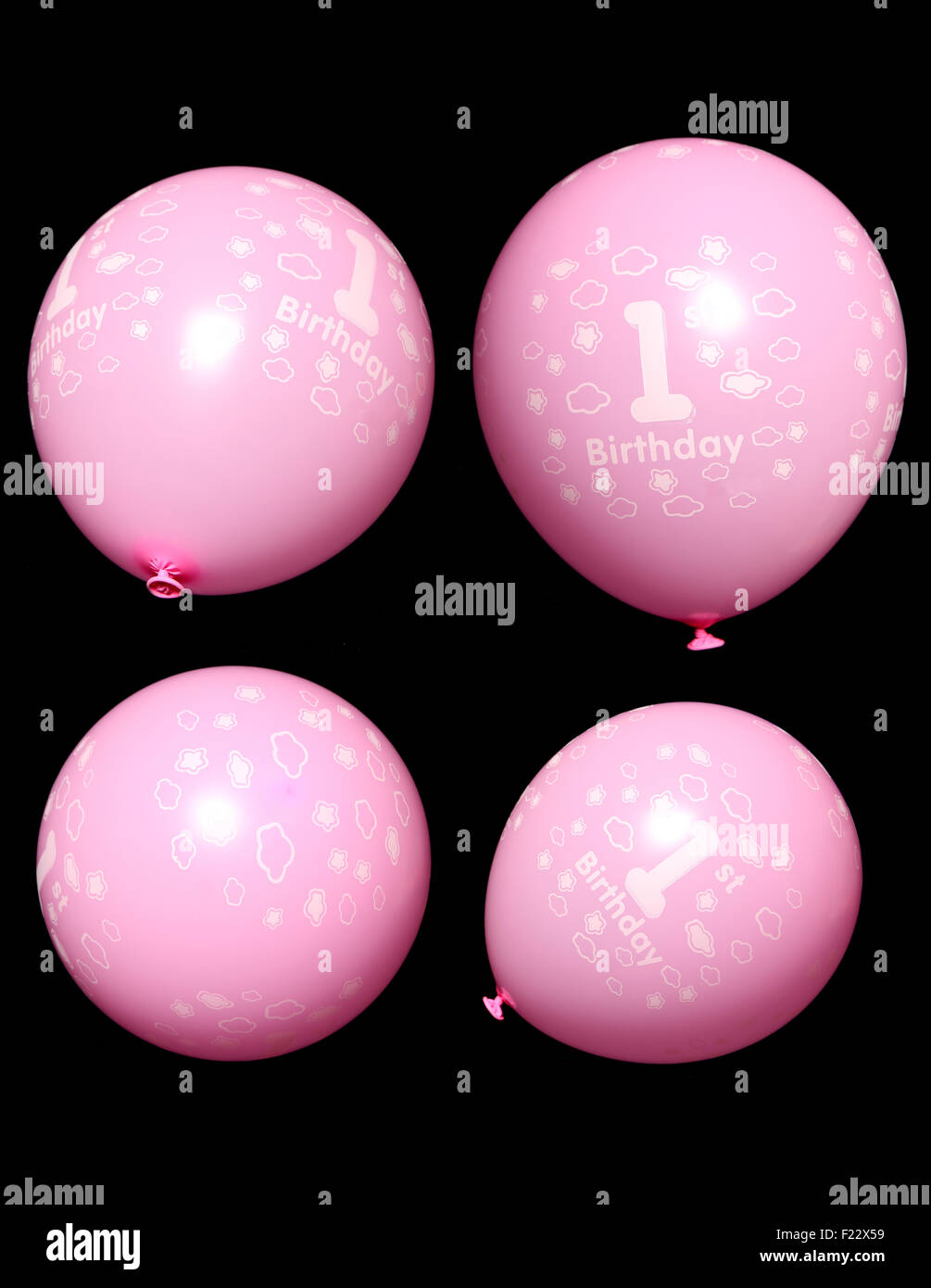 four pink first birthday balloons on black background Stock Photo - Alamy
