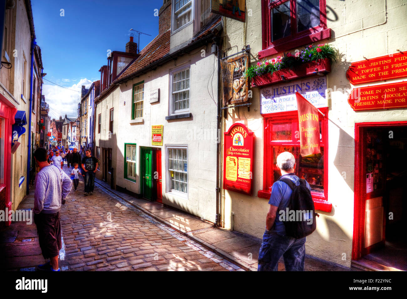 Whitby town narrow street cobbled road shopping area shops tourists ...