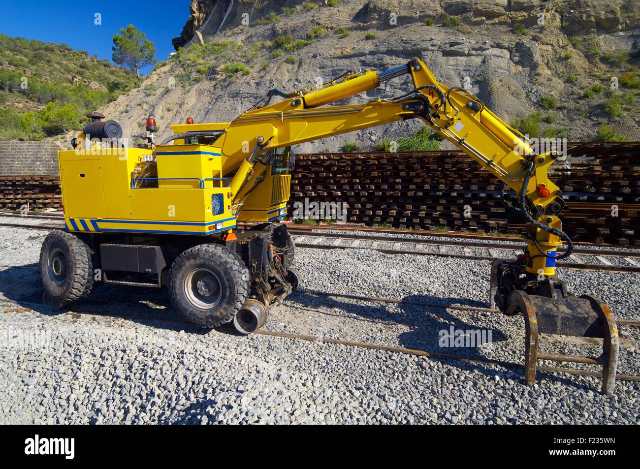 yellow machine repair train tracks Stock Photo - Alamy