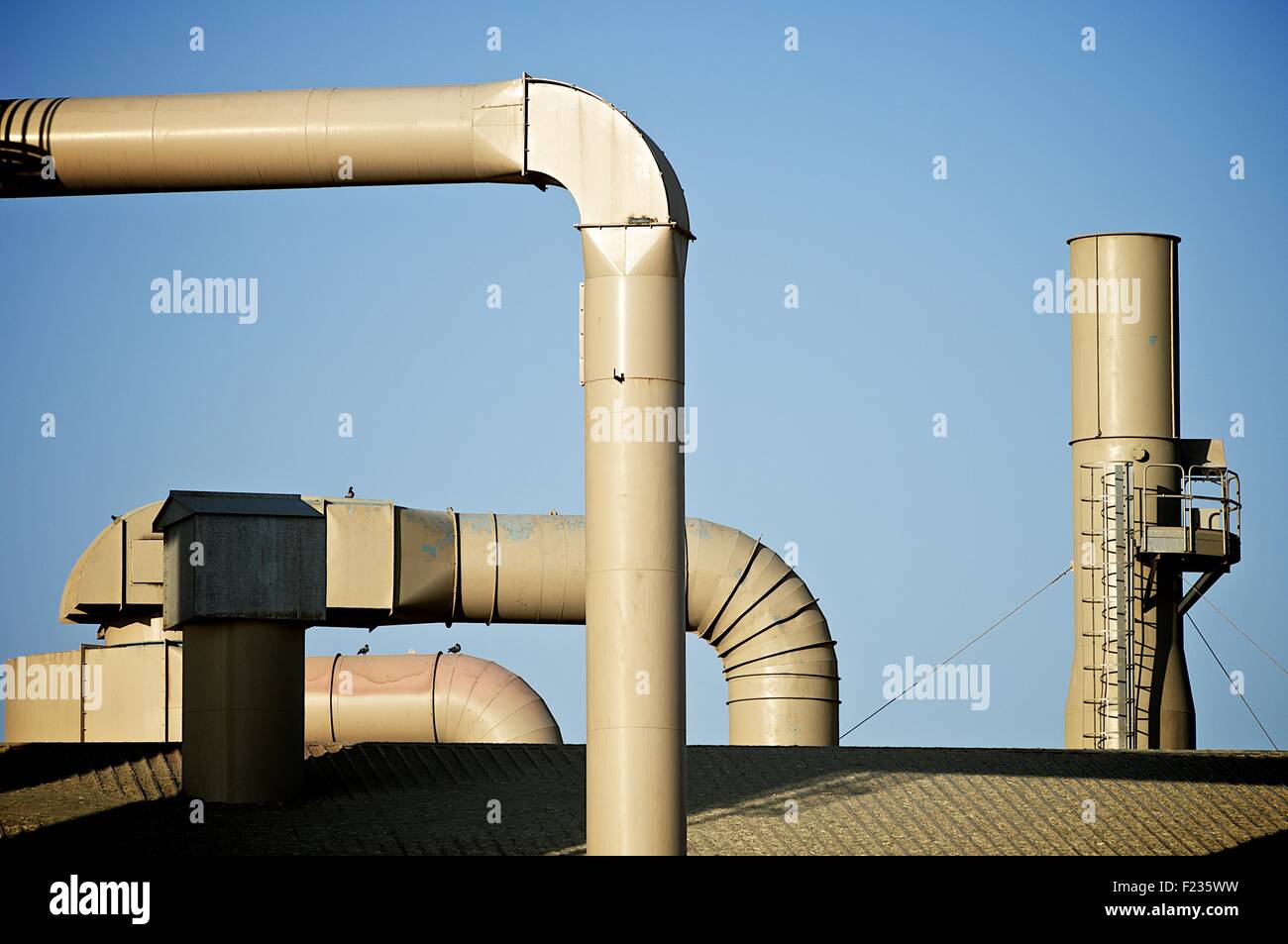 Metal pipes on the facade of a factory Stock Photo - Alamy