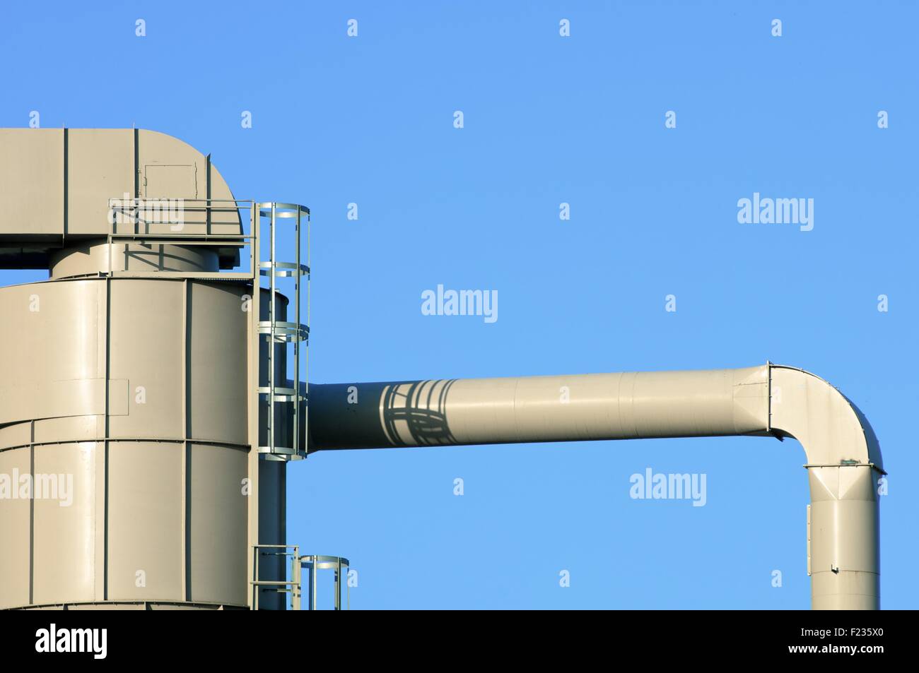 Metal pipes on the facade of a factory Stock Photo - Alamy