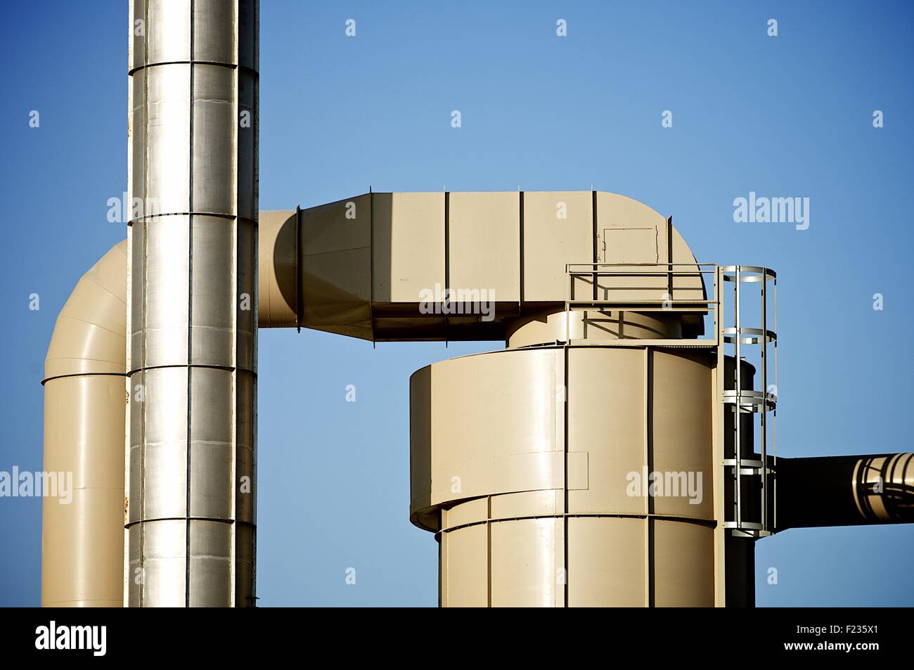 Metal pipes on the facade of a factory Stock Photo - Alamy