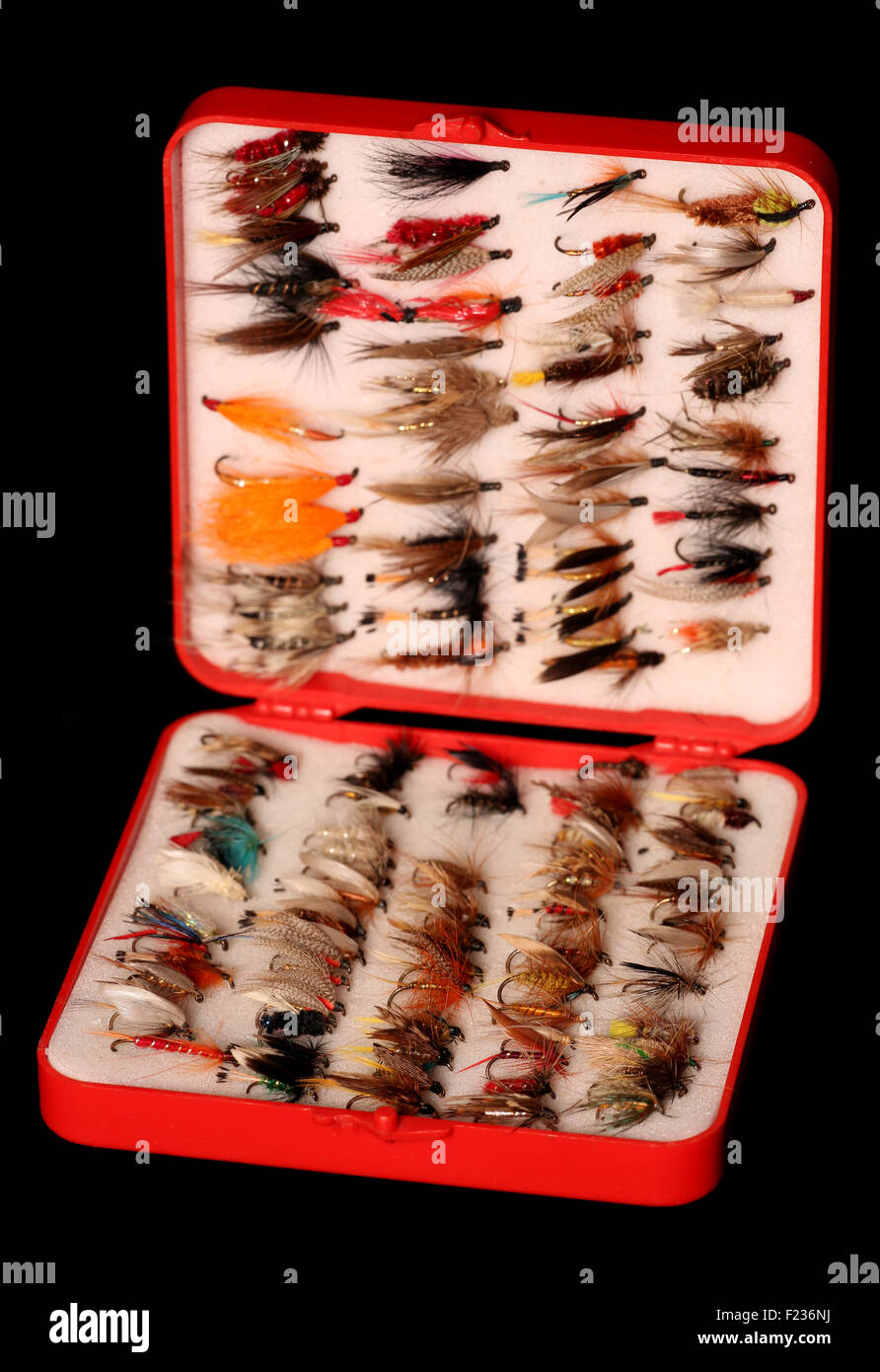 box of fly fishing flies on black background Stock Photo - Alamy